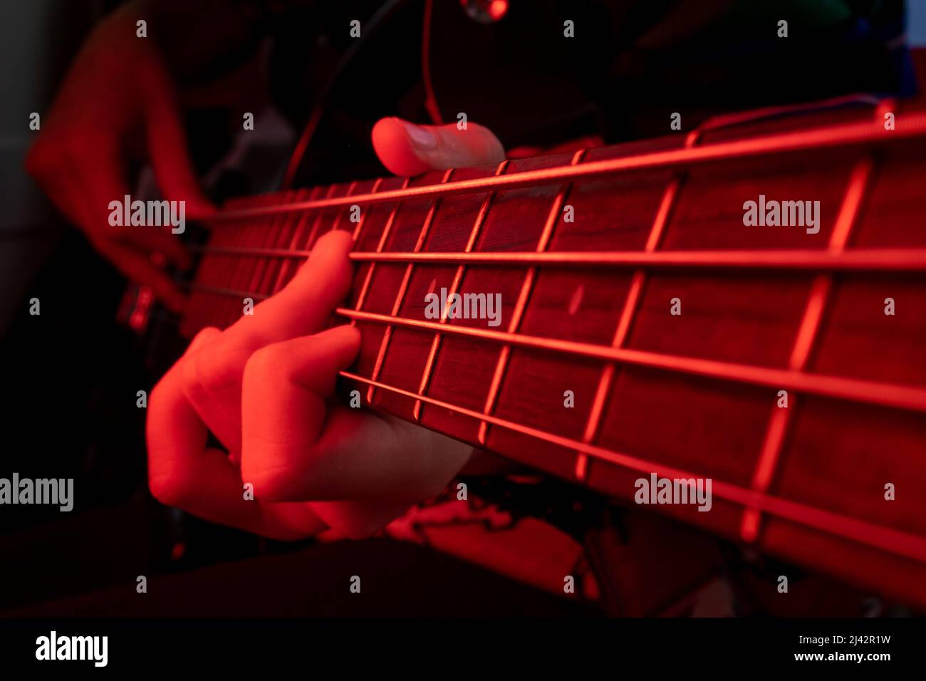 Close-up of an electric bass with a red light Stock Photo - Alamy