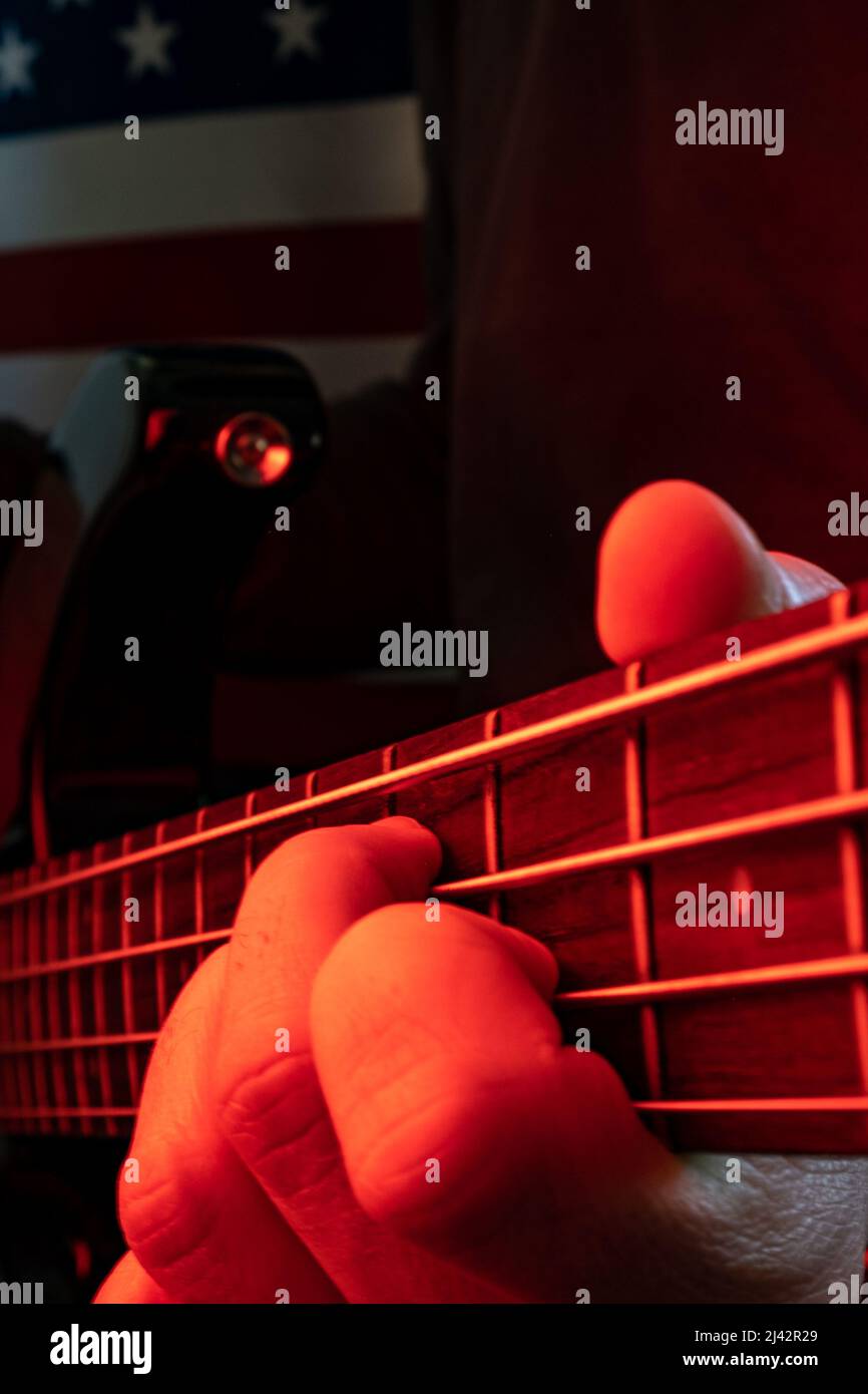 Close-up of an electric bass with a red light Stock Photo - Alamy