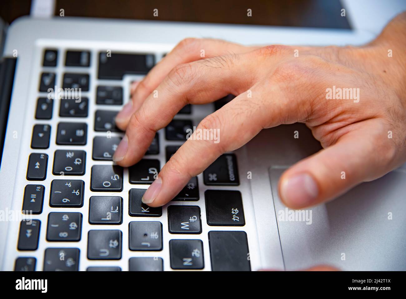 A typing right hand on the laptop computer Stock Photo - Alamy
