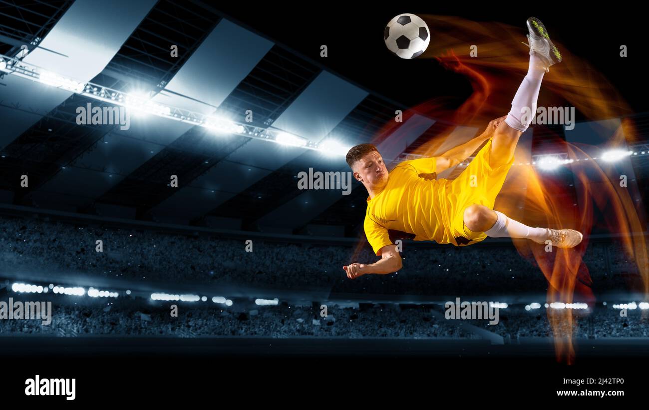 Active professional soccer, football player kick the ball in jump at ...