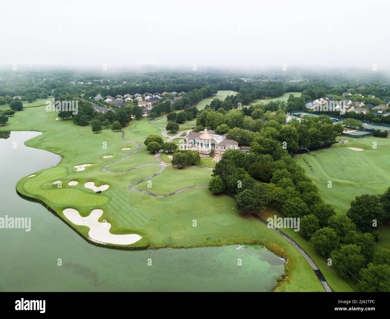 Ariel drone photography from the clouds with golf green and trees in ...