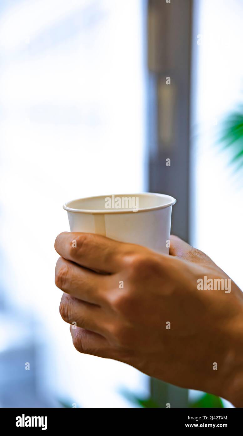 A cup of tea with left hand in the office Stock Photo - Alamy