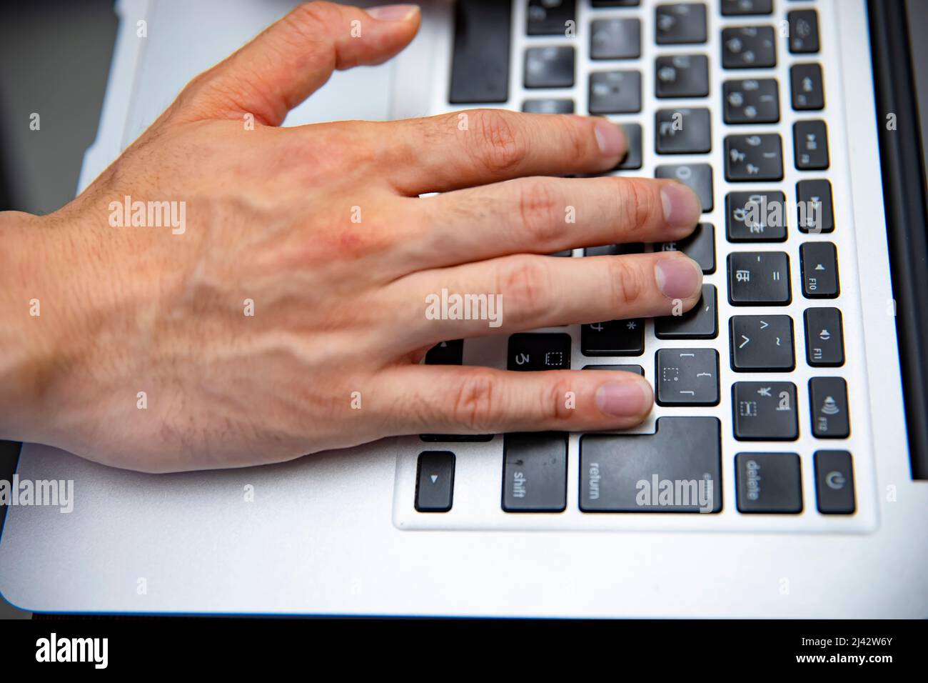 A typing right hand on the laptop computer Stock Photo - Alamy