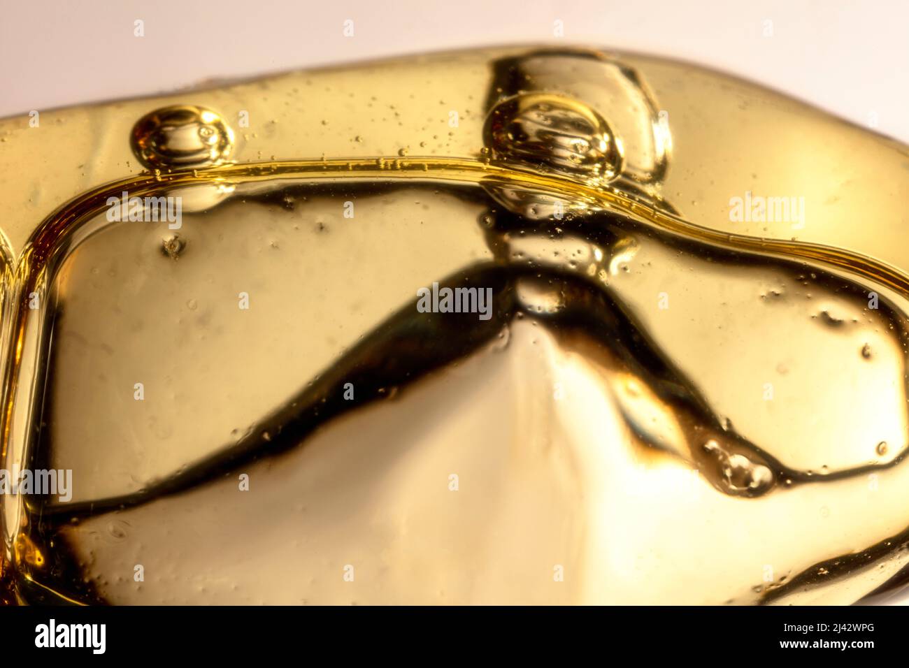 Macro still-life showing abstract patterns in Omega-3 oil capsule ...