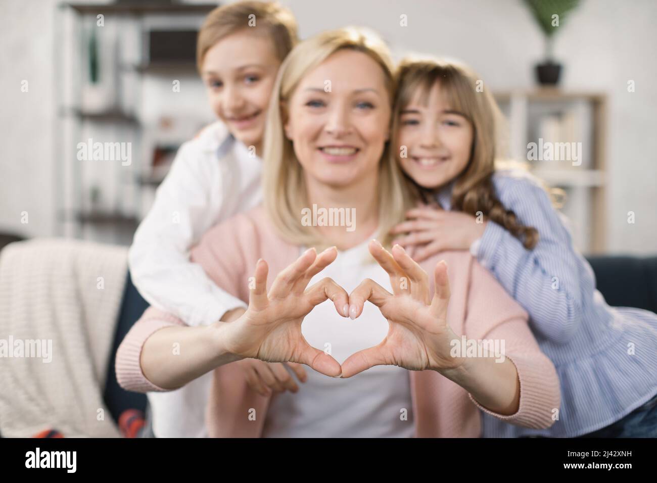 Portrait of little happy girl and boy and mother join hands forming ...