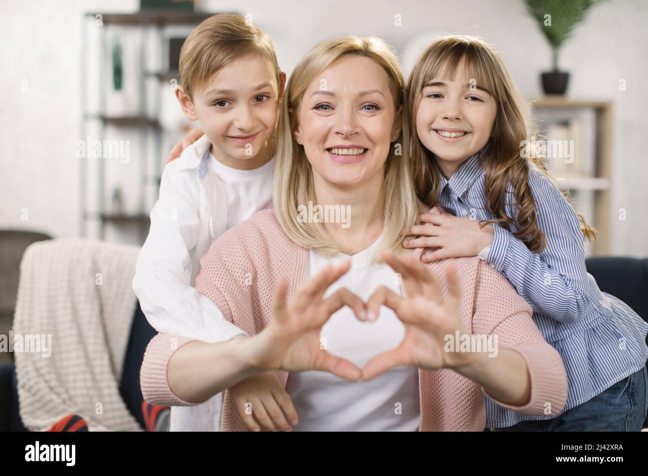 Portrait of little happy girl and boy and mother join hands forming ...
