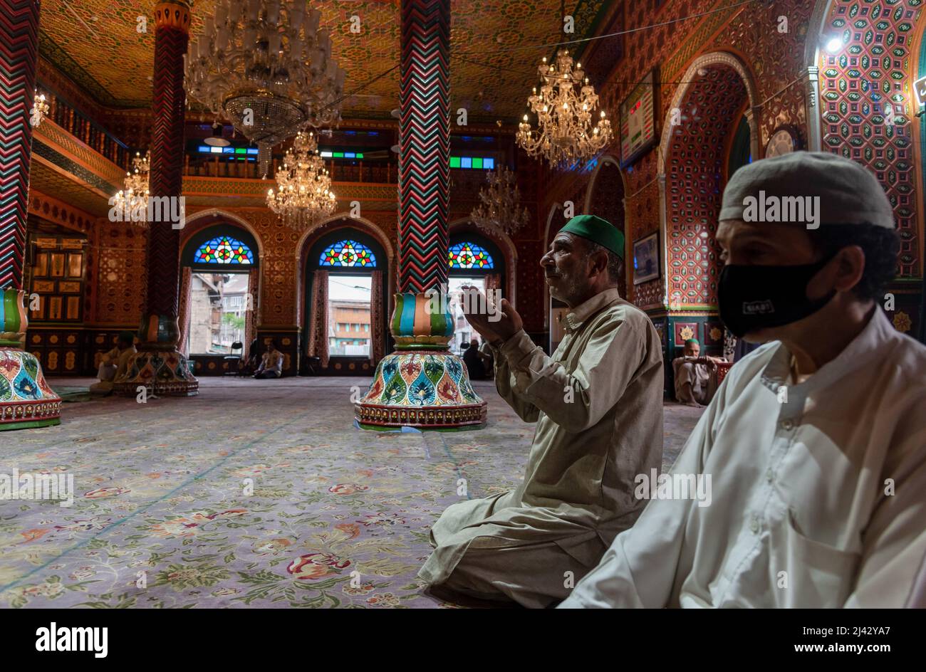 A Muslim devotee prays inside a shrine during Islamic holy month ...