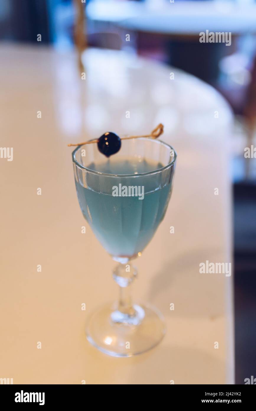 Glass of a cocktail place on white marble bar Stock Photo - Alamy