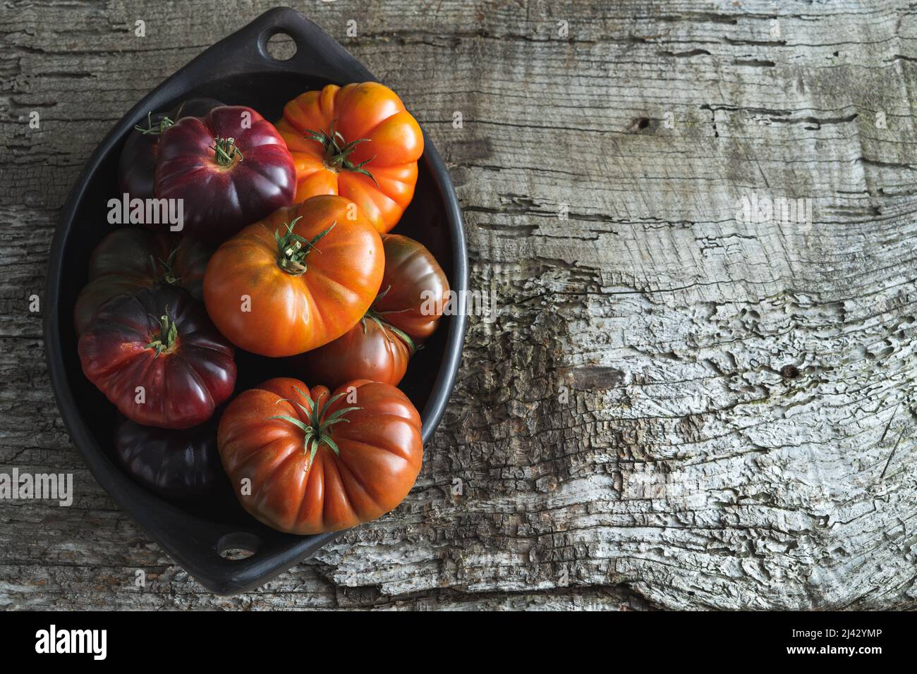 Tray with raf tomatoes and blue sea on old wood background. Copy space ...