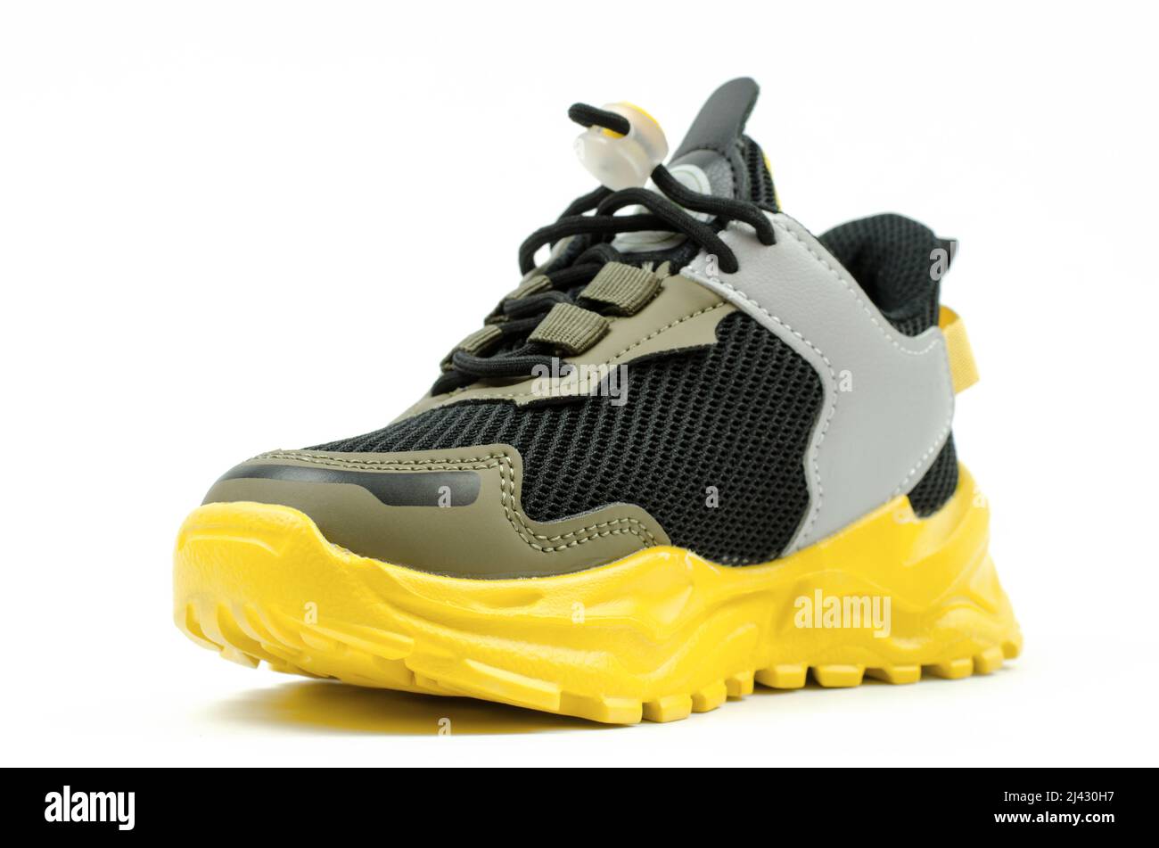 Sports sneaker with yellow sole isolated on white background. Khaki ...