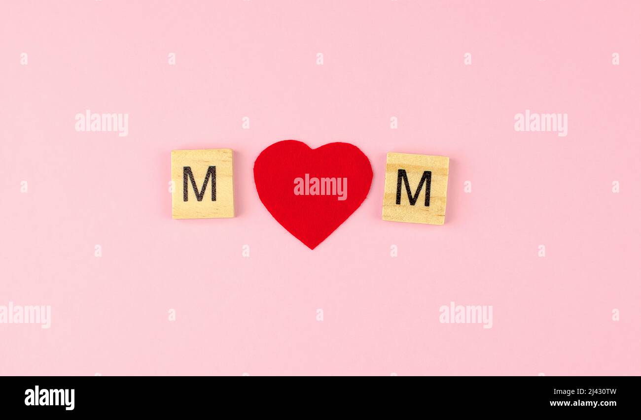 The word mom from wooden letters, instead of the letter O red heart ...