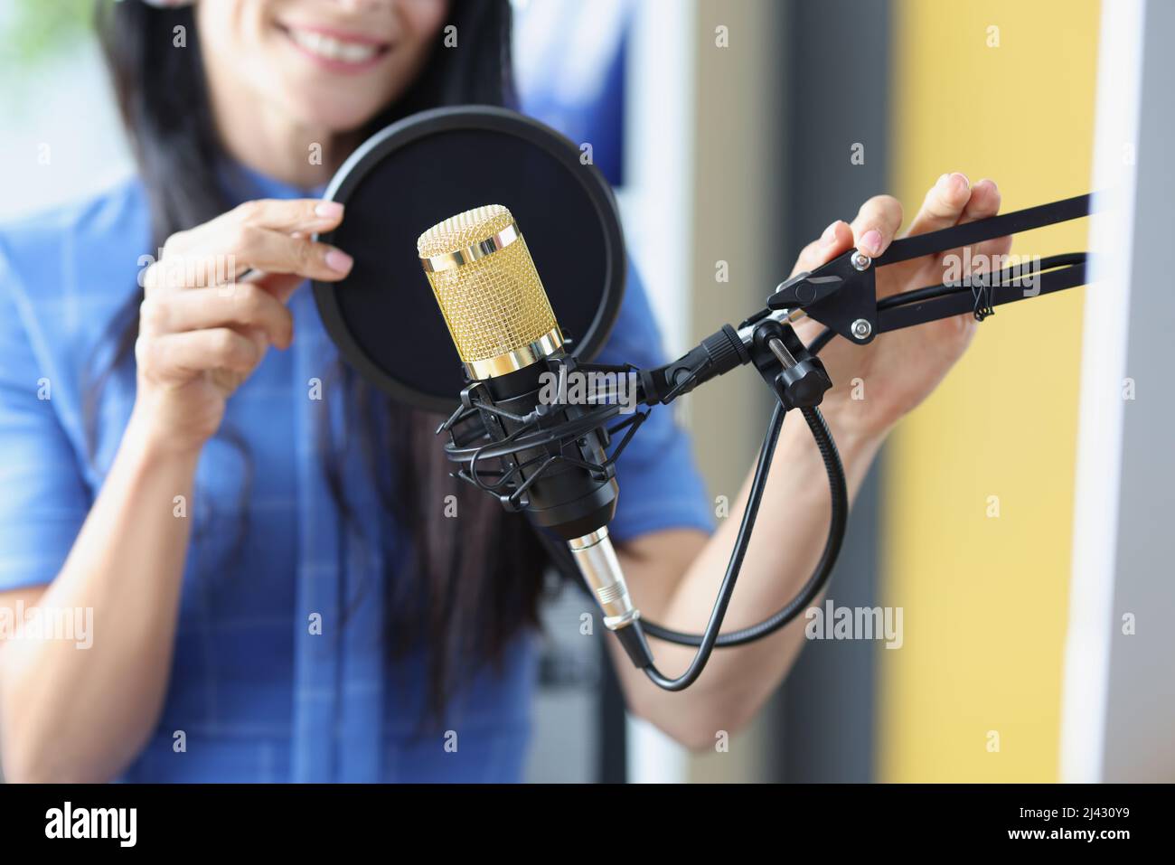 Radio presenter works adjusts microphone, prepares speak before ...