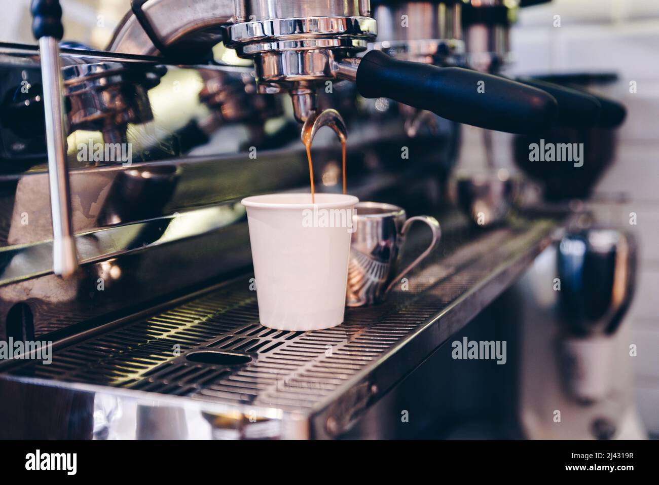 Espresso coffee pouring from machine hi-res stock photography and ...