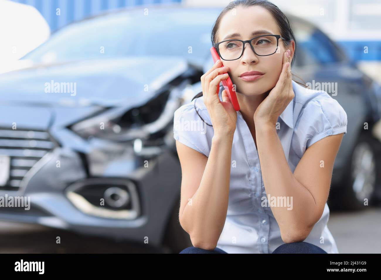 Sad woman talking on phone after broken car Stock Photo - Alamy
