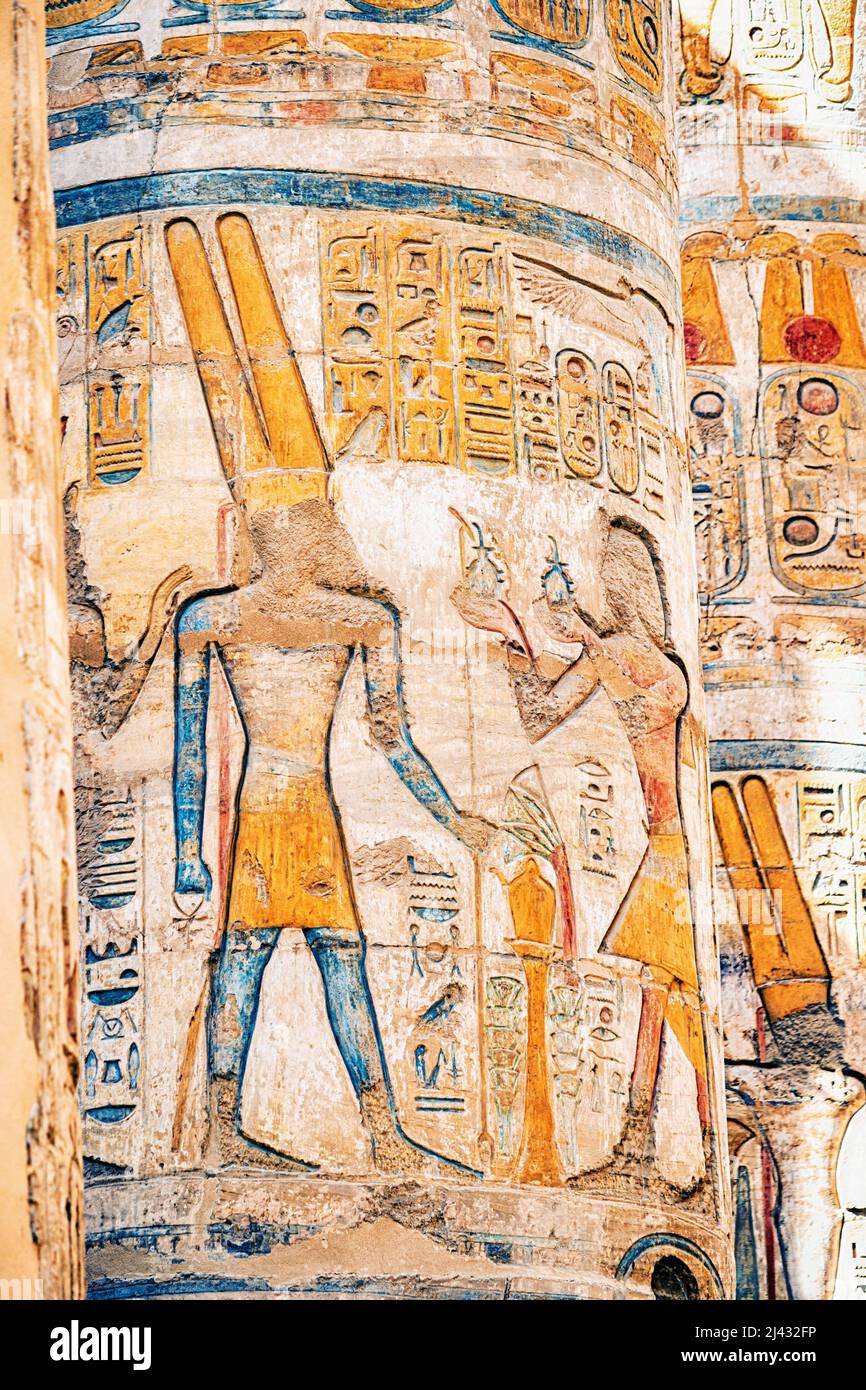 hieroglyphs and drawings of pharaohs carved in sandstone column in ...