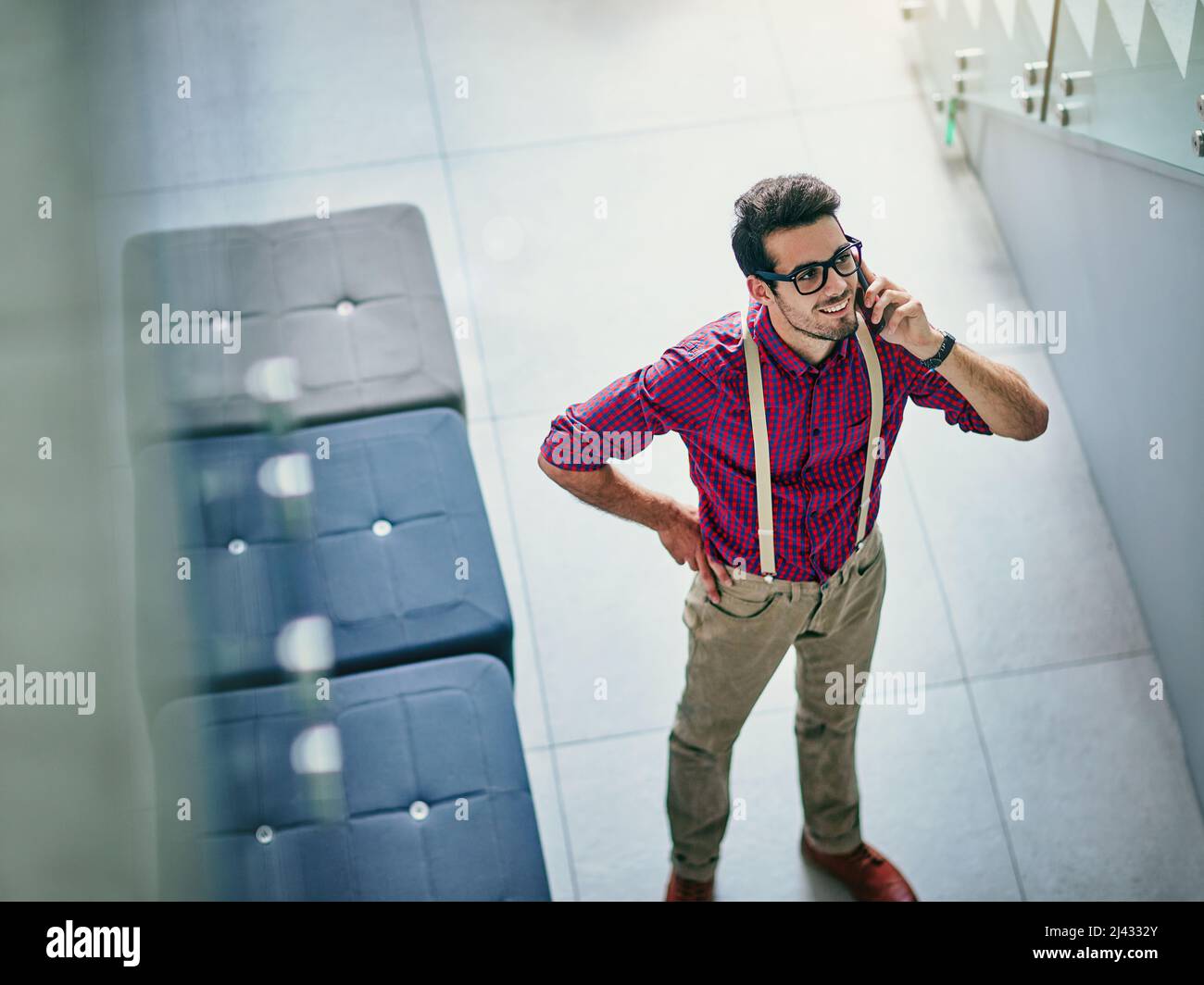 Im listening.... High angle shot of a handsome young designer talking ...