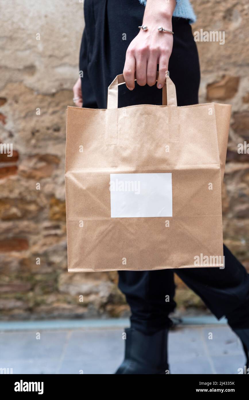 Female hands holding paper bag Stock Photo - Alamy
