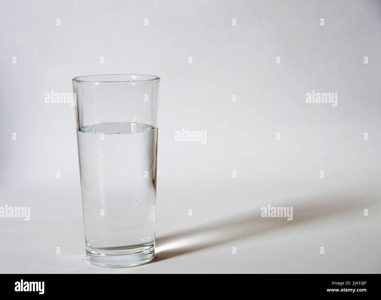Transparent glass with water isolated on white background with shadows ...
