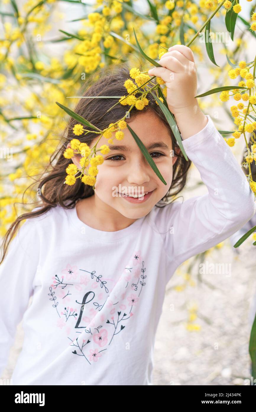 Spring Girl. Happy Child Holding Branch Of Tree With Yellow Flowers In ...