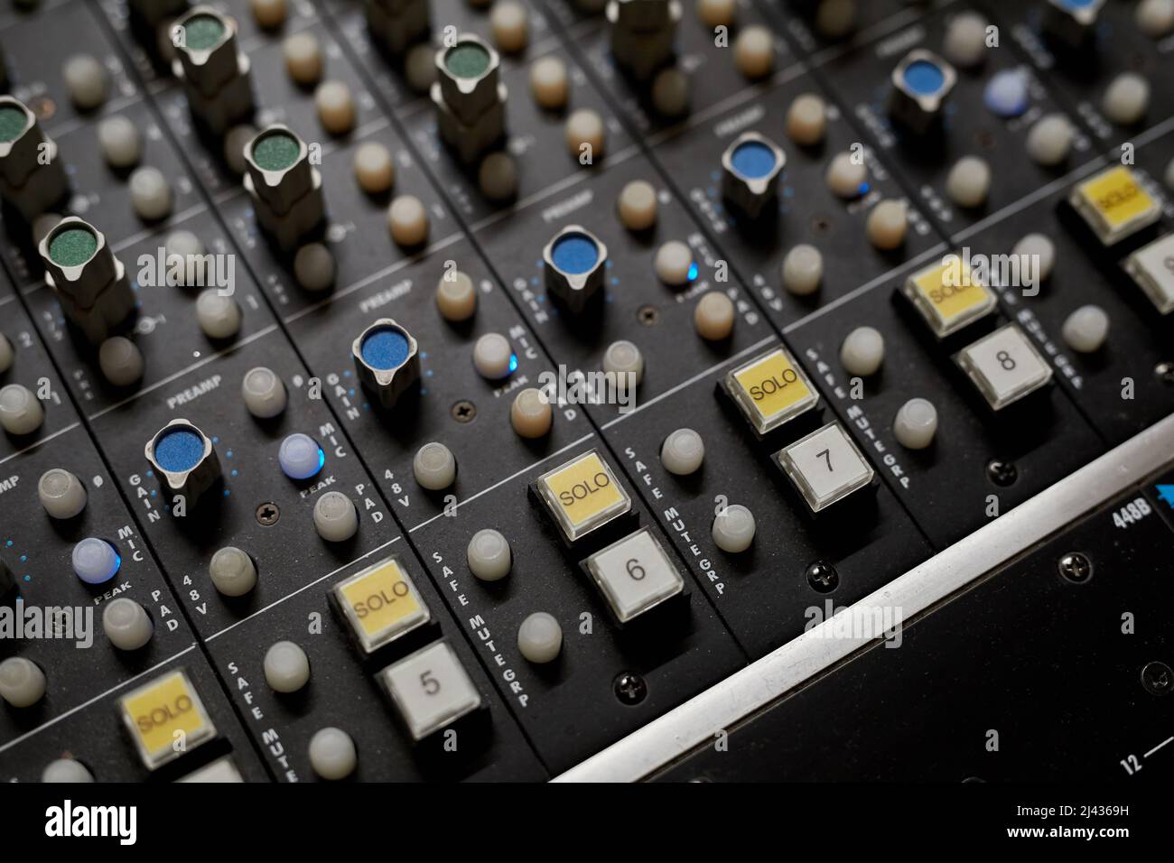 Close up of sound board with buttons and toggles in music recording ...