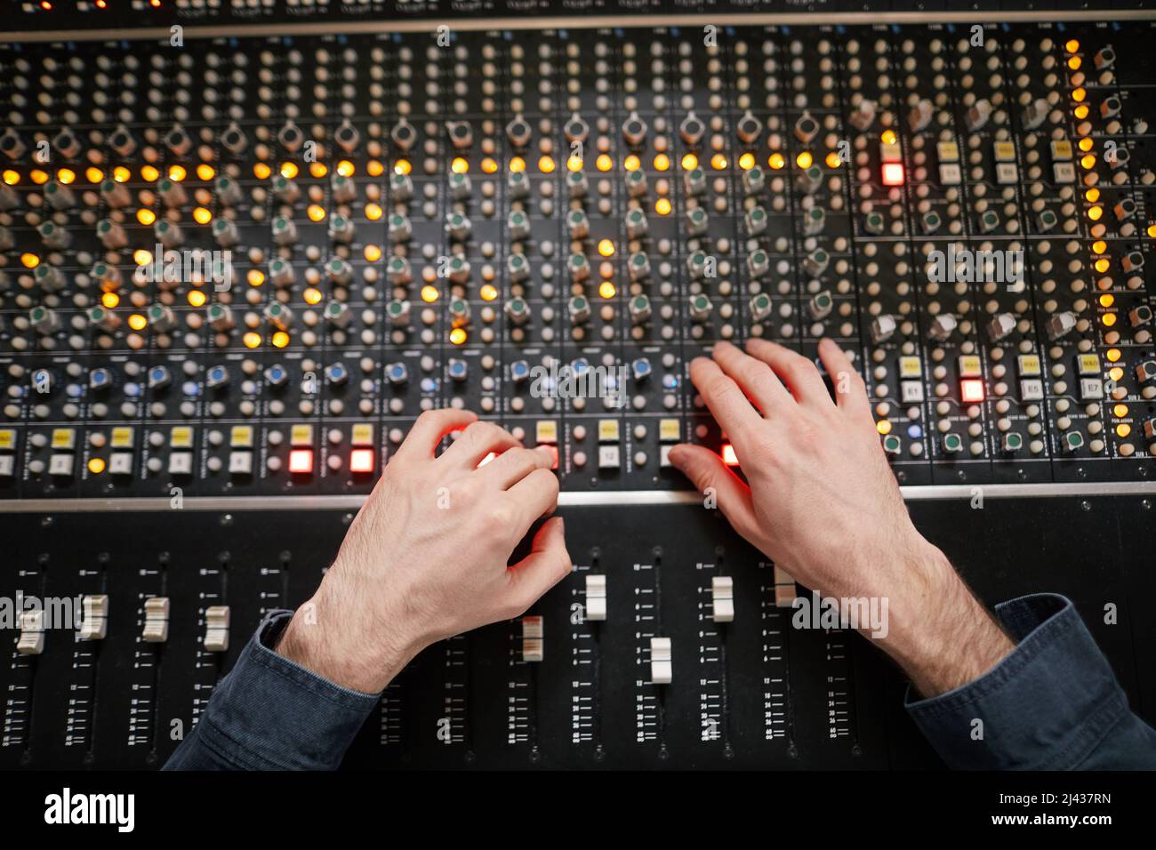 Top view background of male hands operating buttons and toggles at ...