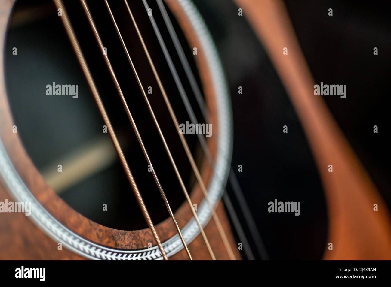 An angled view of the sound hole of an acoustic guitar Stock Photo - Alamy