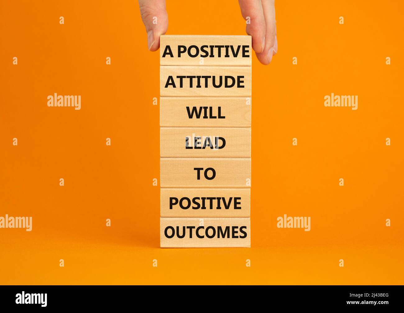 Think positive symbol. Wood blocks with words A positive attitude will ...