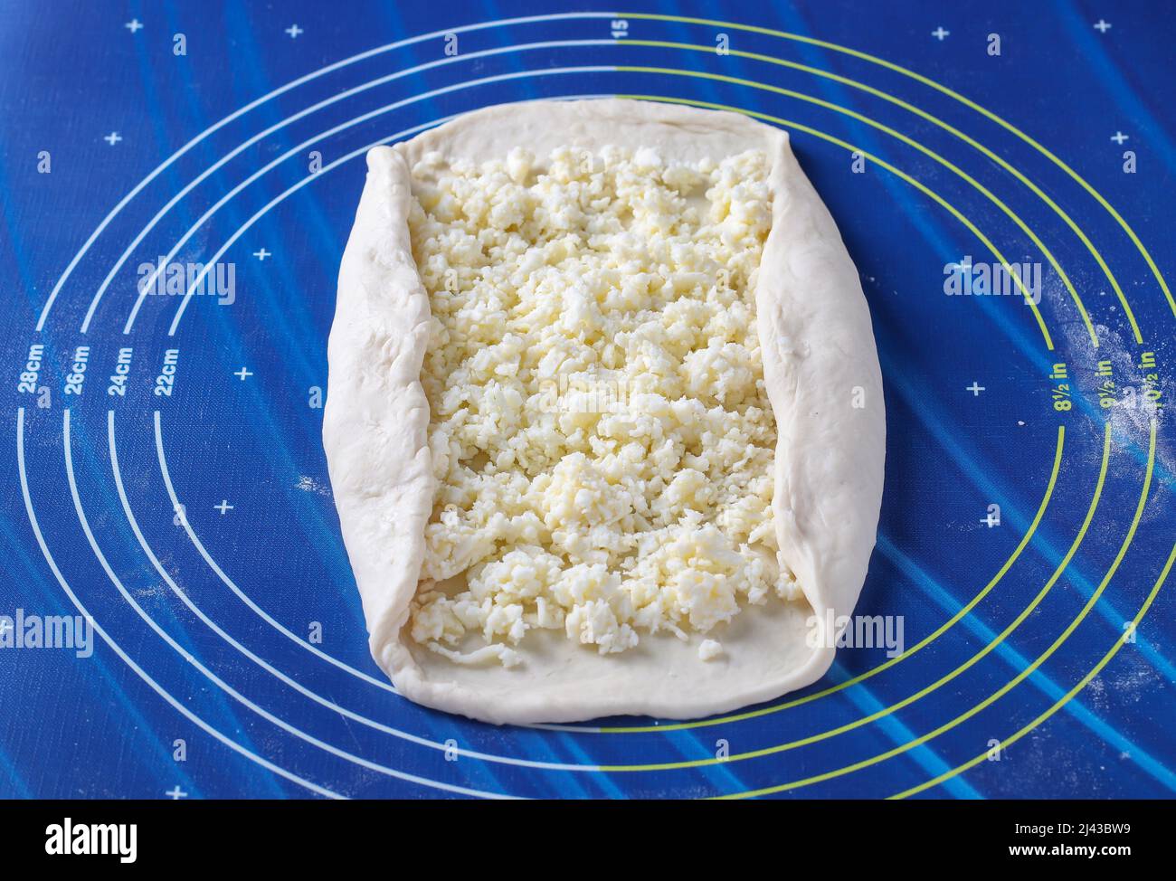 Process of preparing Georgian khachapuri with cheese, a round cake is ...