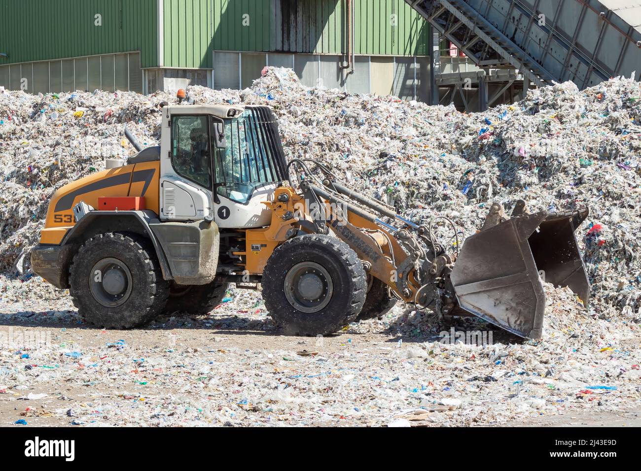 Heavy machinery working with recycled paper in a industrial recycling ...
