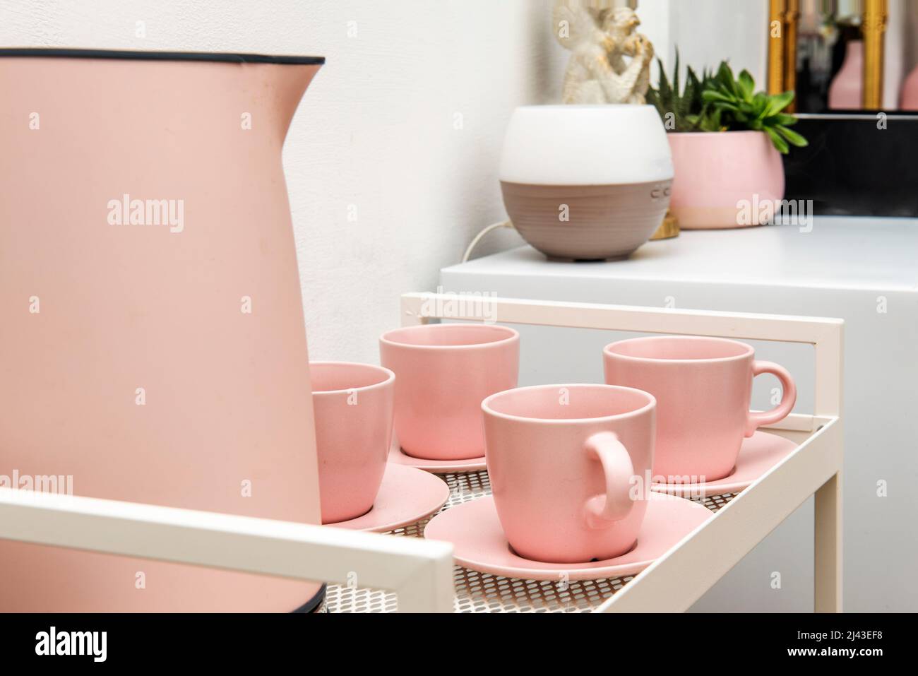 Set of pink porcelain cups with matching saucers and a matching colored ...