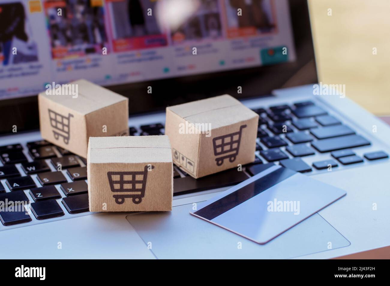 Shopping online. Credit card and cardboard box with a shopping cart ...