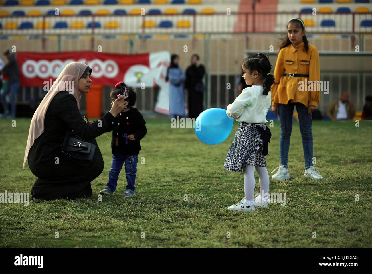 Gaza, Palestine. 11th Apr, 2022. A Palestinian woman takes pictures of ...