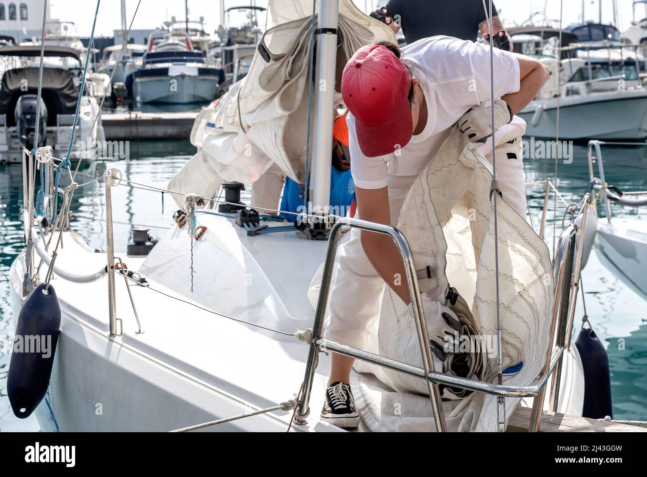 Yachtsman checking sail before regatta Stock Photo - Alamy