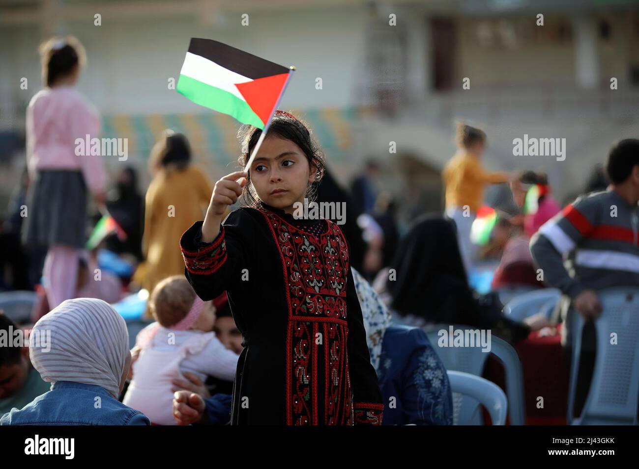 A Palestinian child seen carrying the Palestinian flag during a party ...