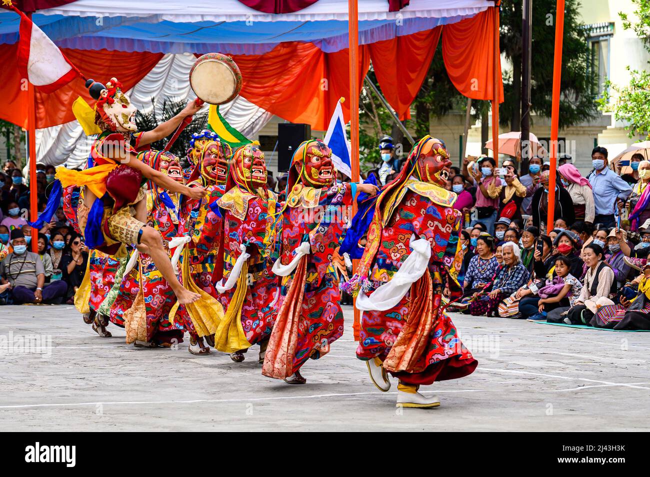 Masked dancers dressed in the traditional attire performe a spiritual ...