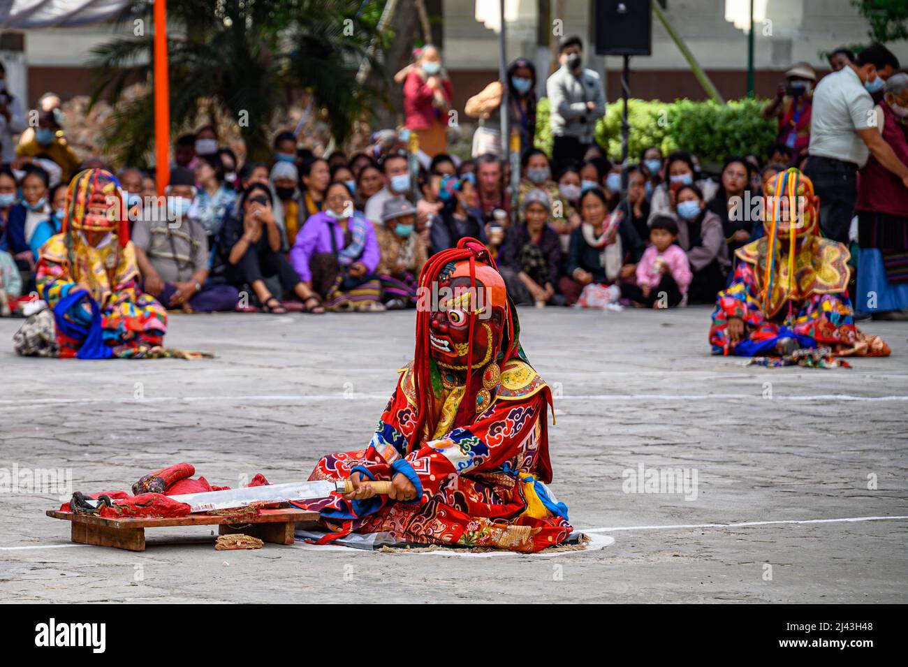 Masked dancers dressed in the traditional attire performe a spiritual ...
