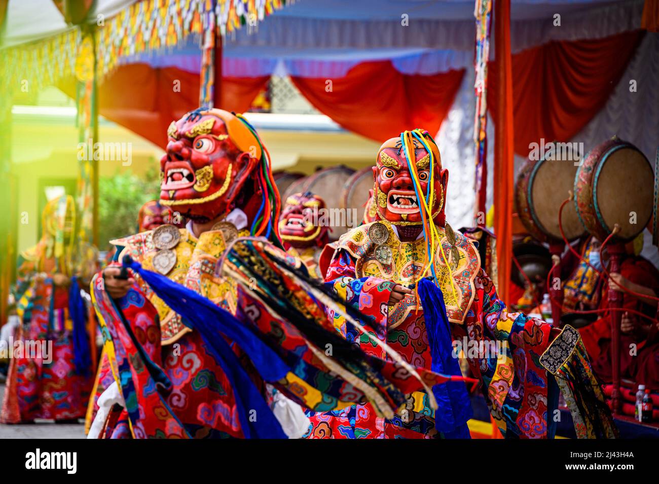Masked dancers dressed in the traditional attire performe a spiritual ...