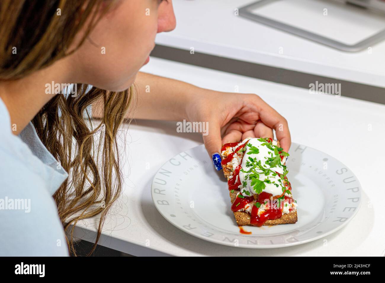 Decorative open delicious sandwich. Teen girl eating homemade wheat ...