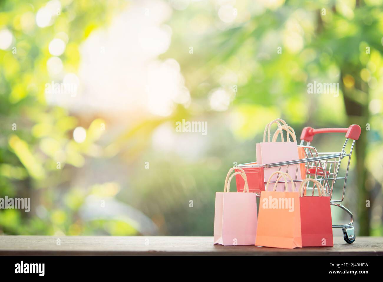 Shopping concept - Shopping cart or trolley, Shopping bags on wood ...