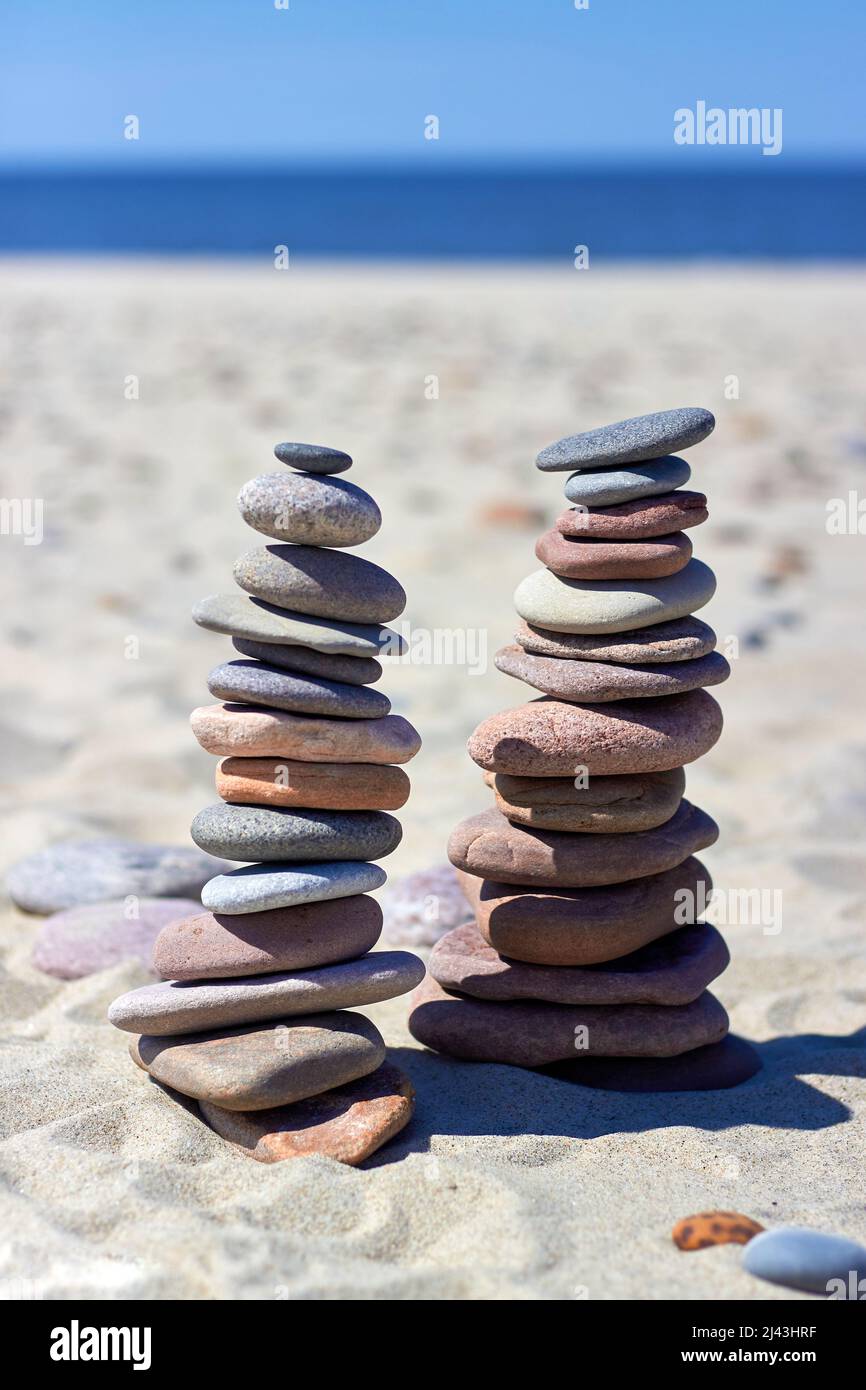Two pyramid of stones on a sandy beach. Zen balance stones Stock Photo ...