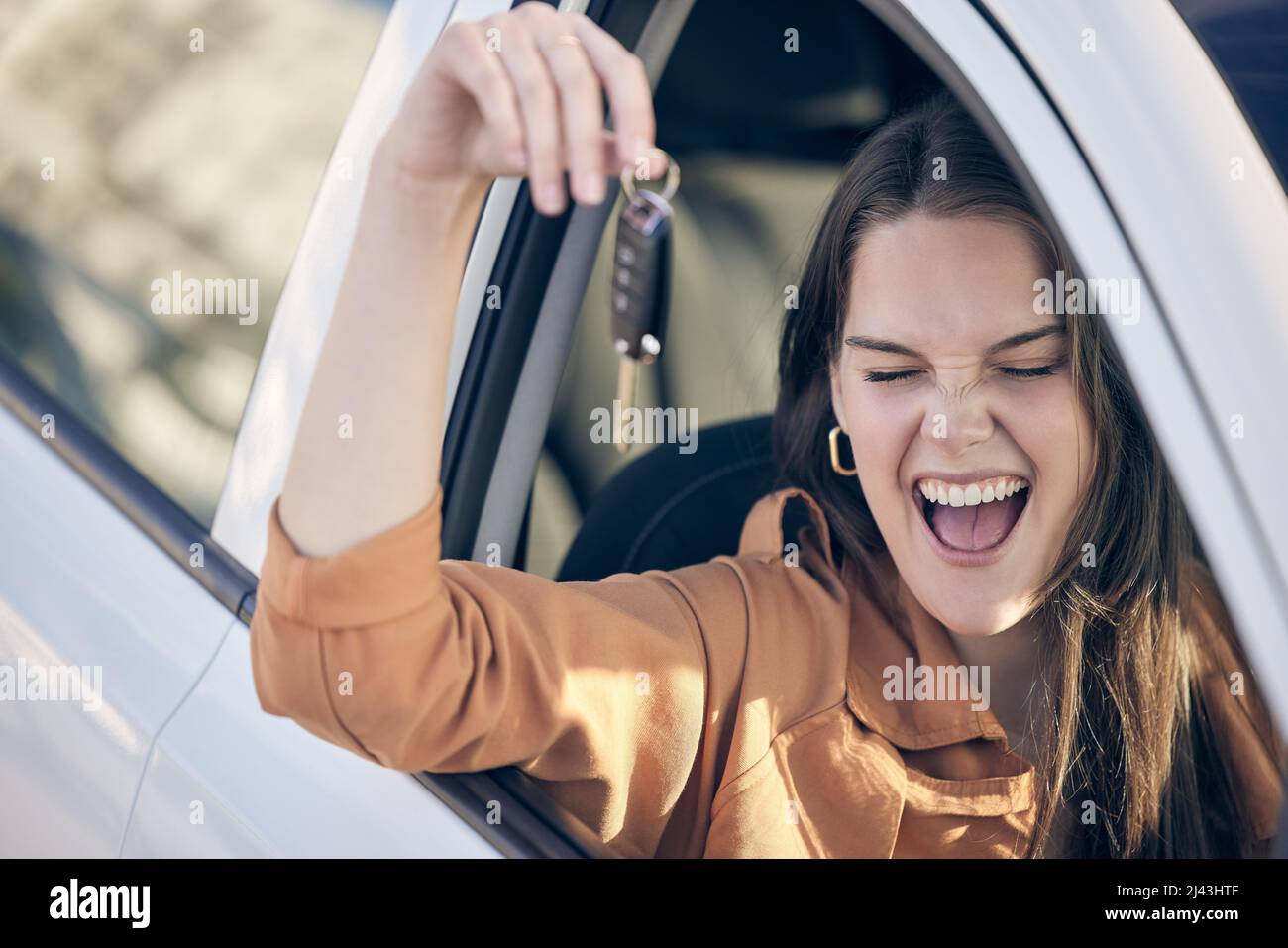 Drive slow and enjoy the scenery. Shot of a woman holding the keys to ...