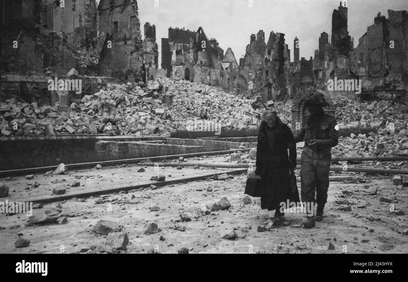 Aftermath Of Battle For Caen (July 10) -- A British soldier gives a ...