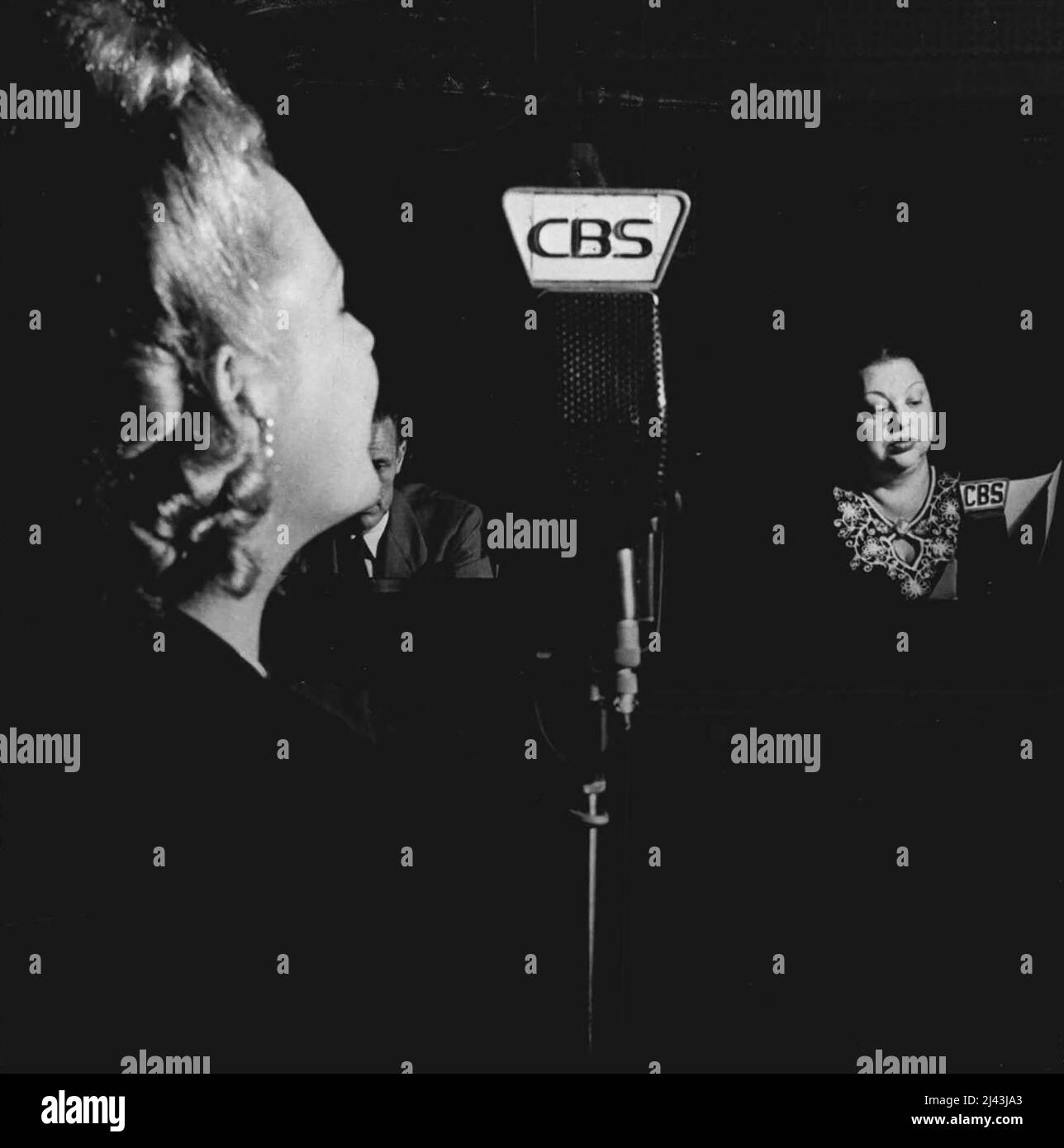 Bessie Mack, right, listens from control booth as model Helen Manning ...