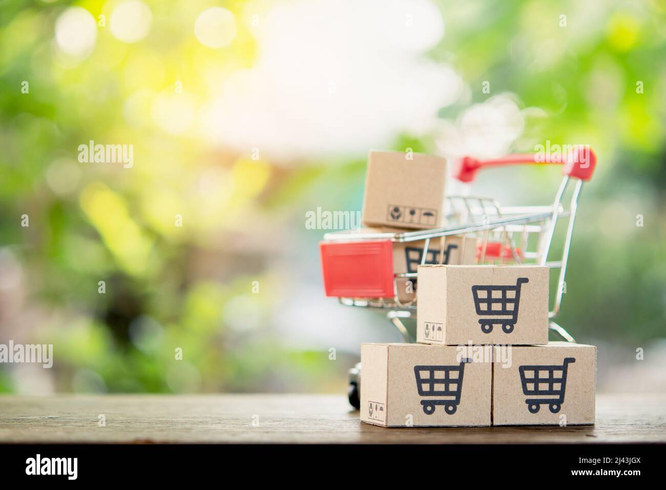 Shopping concept - Shopping cart or trolley and Paper cartons or parcel ...