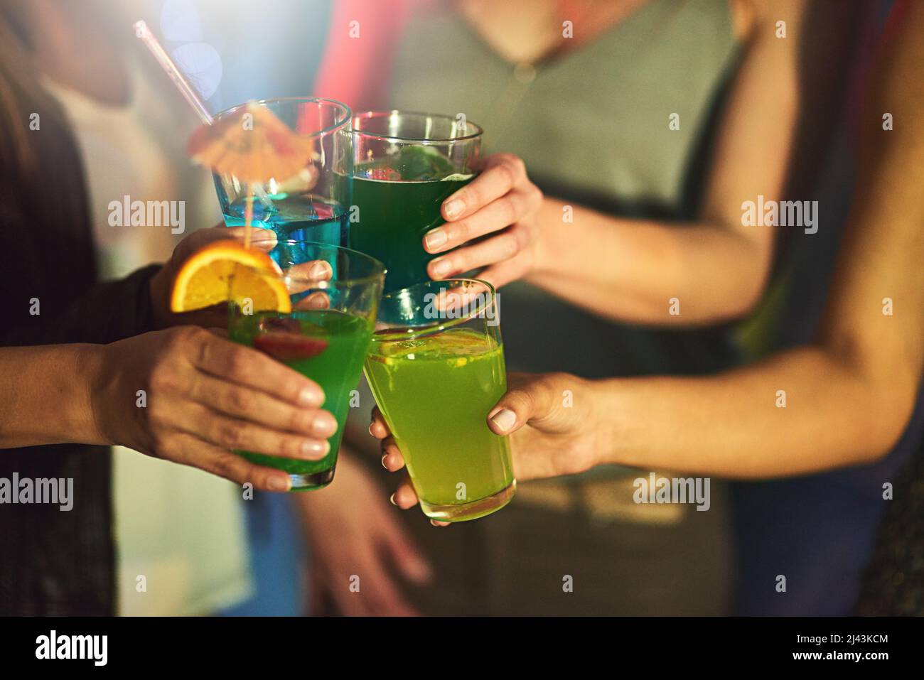 Cheers ladies Heres to us. Cropped shot of a group of women toasting ...