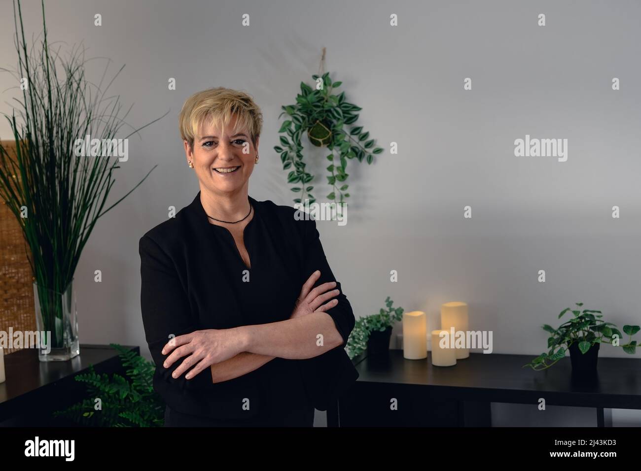 Mature female beautician, owner of a small beauty salon. Woman posing ...