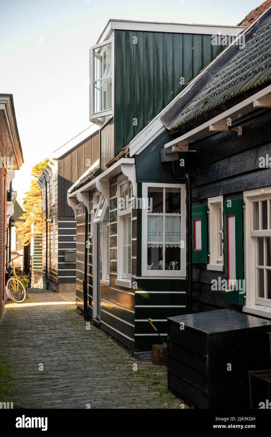 Walking on sunny spring day in small Dutch town Marken with wooden ...