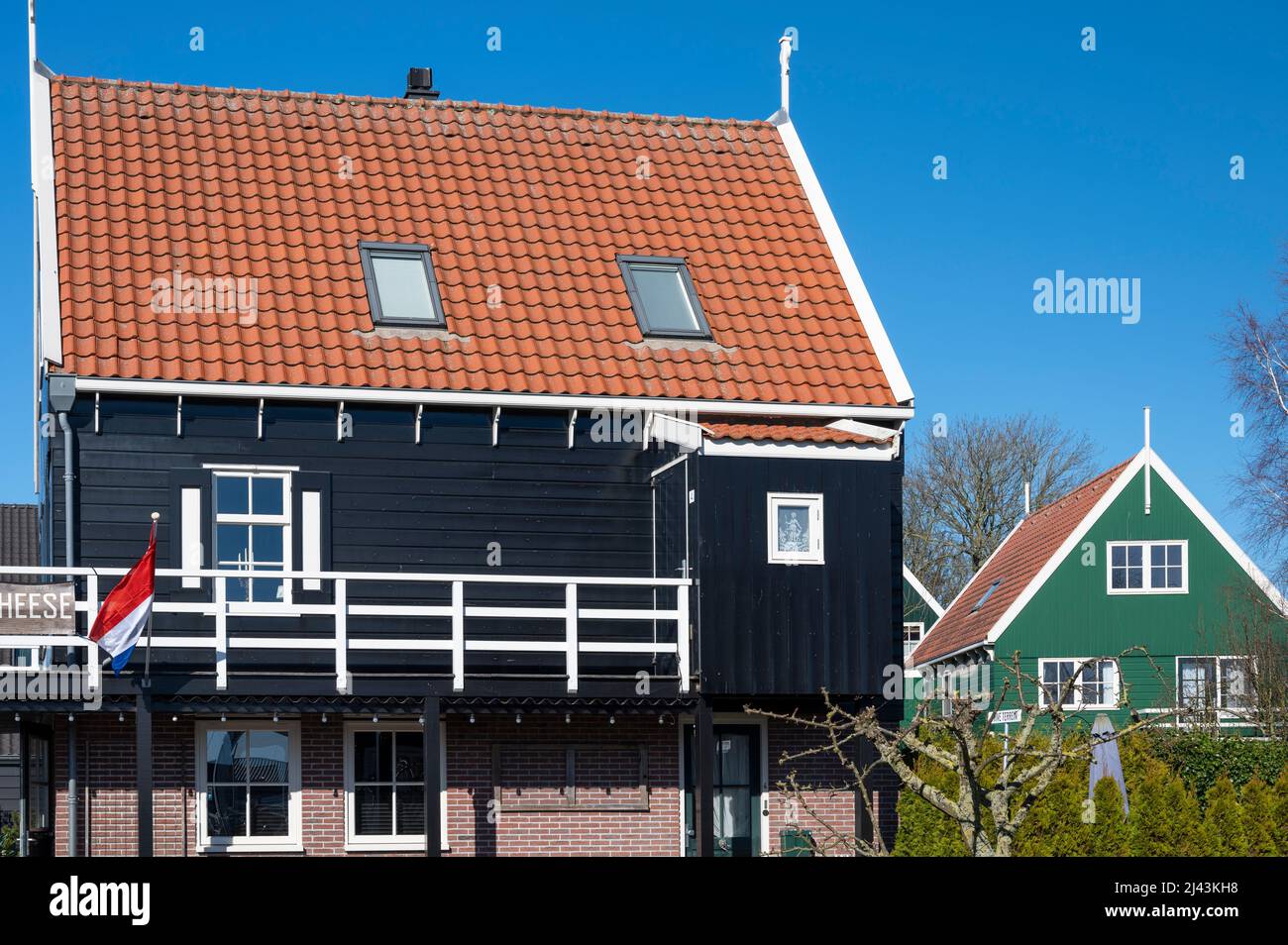 Walking on sunny spring day in small Dutch town Marken with wooden ...