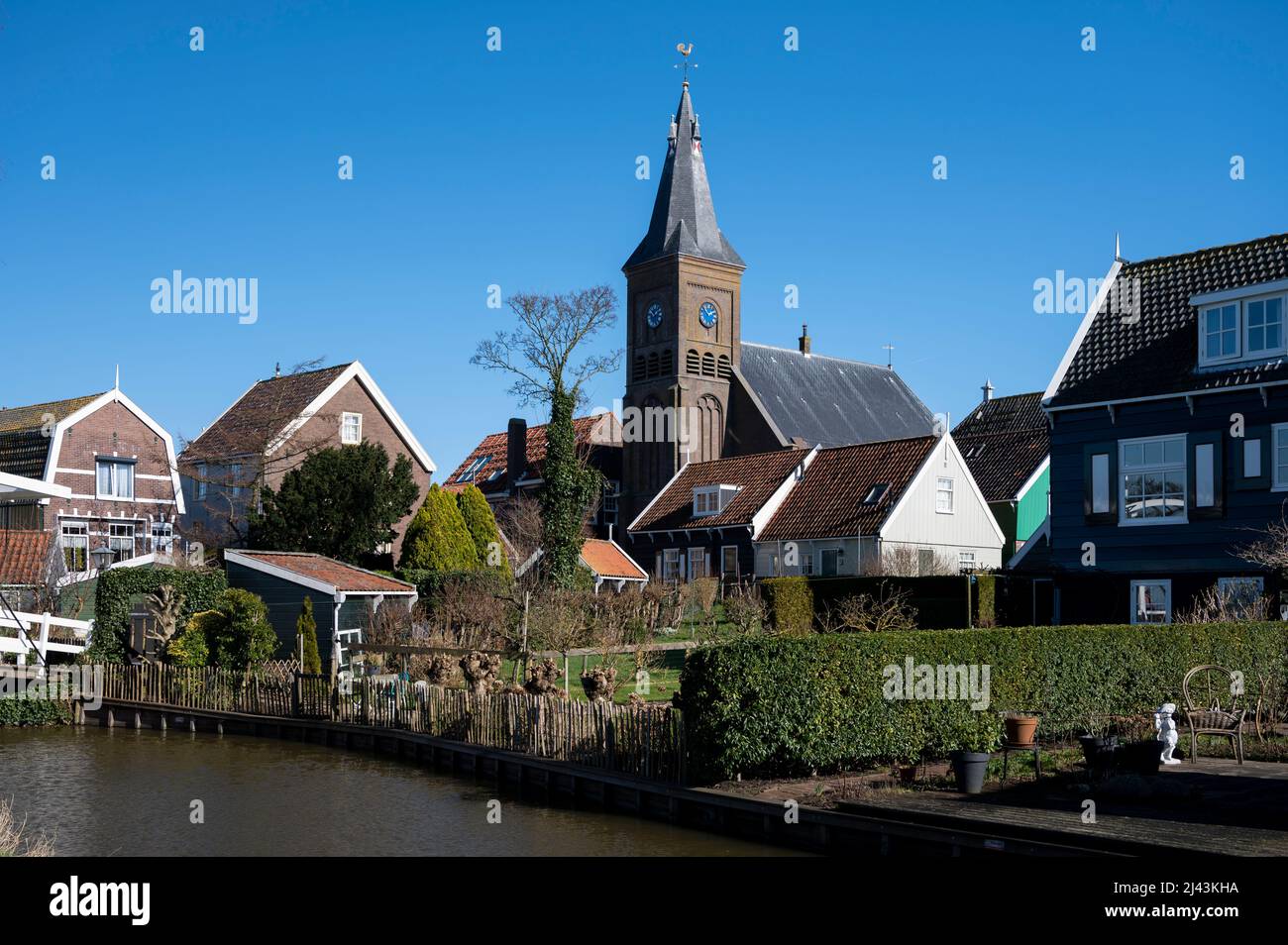 Walking on sunny spring day in small Dutch town Marken with wooden ...
