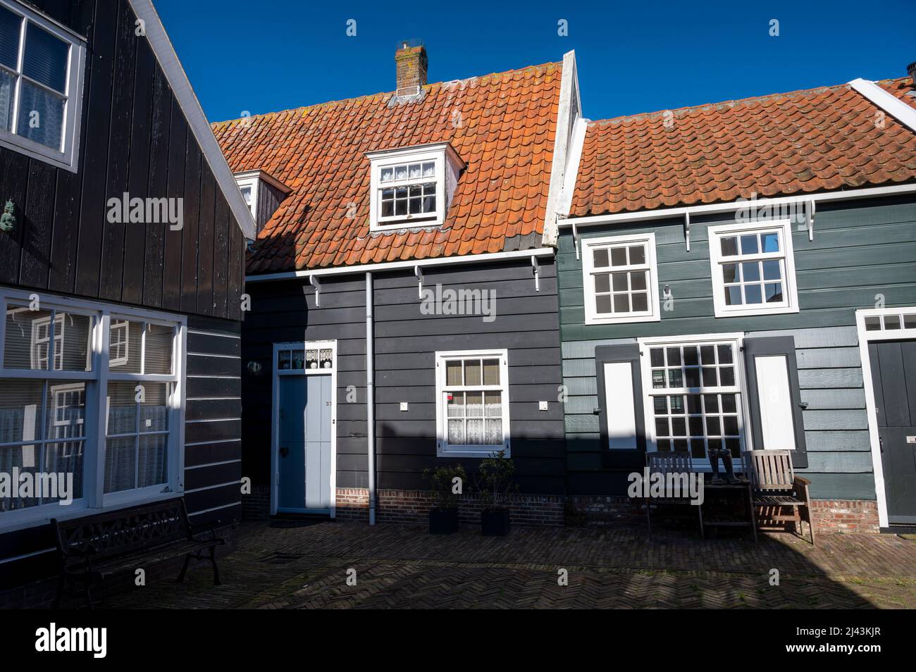 Walking on sunny spring day in small Dutch town Marken with wooden ...